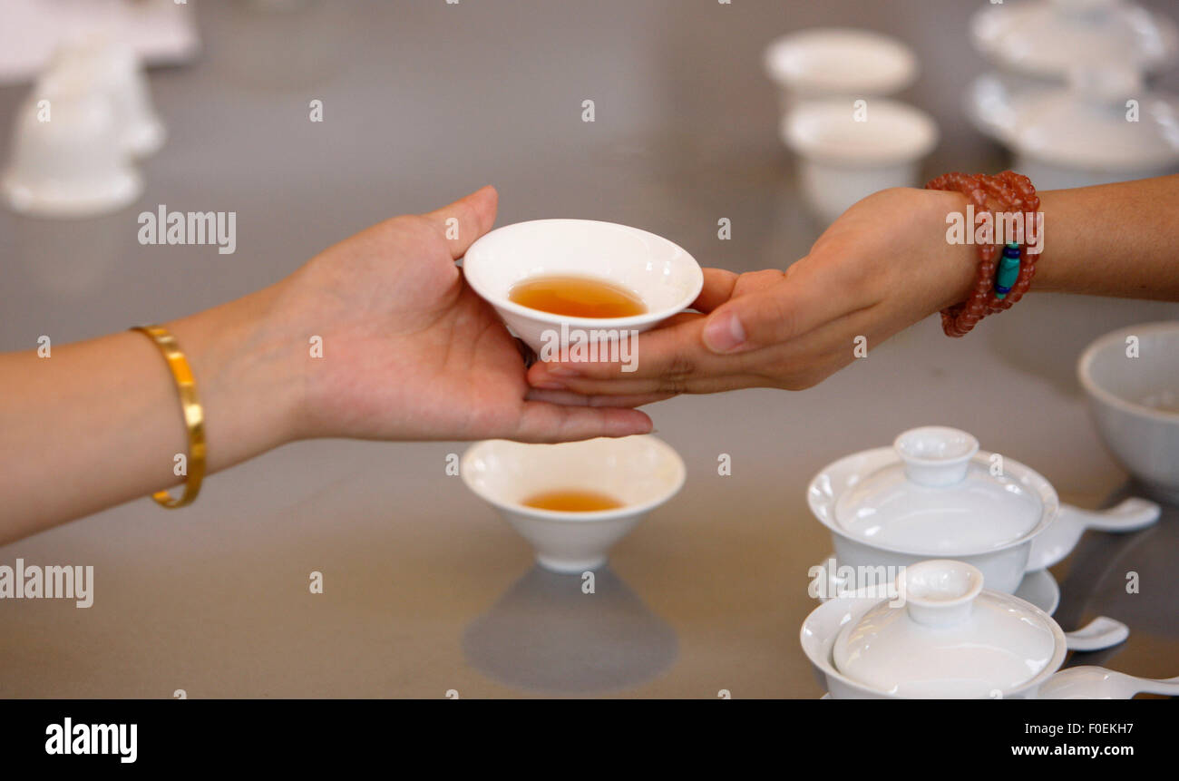 Xinzhou, China's Shanxi Province. 11th Aug, 2015. A tea master hands a ...