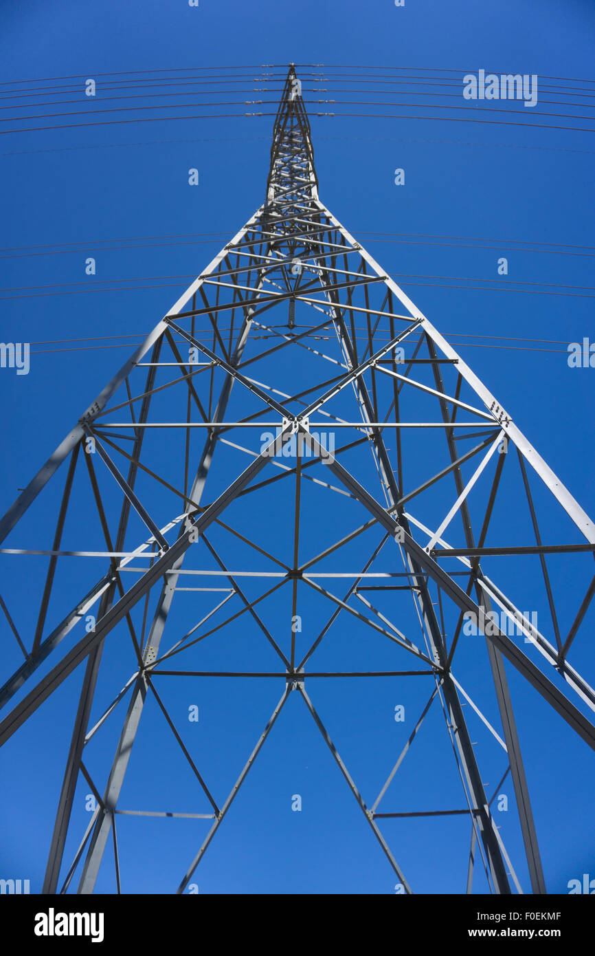 Metal electric power line tower stands under a bold blue sky Stock ...
