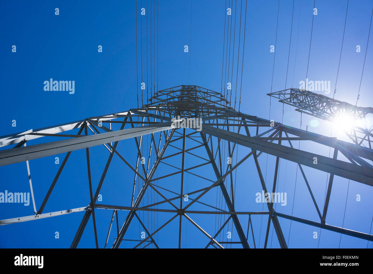 Looking up the electric tower structure holding wires Stock Photo - Alamy