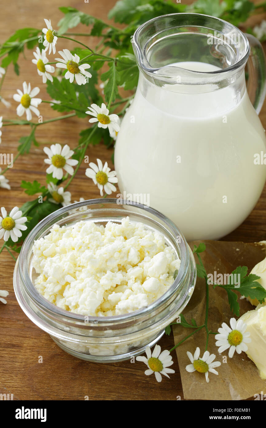 fresh cottage cheese in a bowl with a jug of milk, rustic style Stock ...