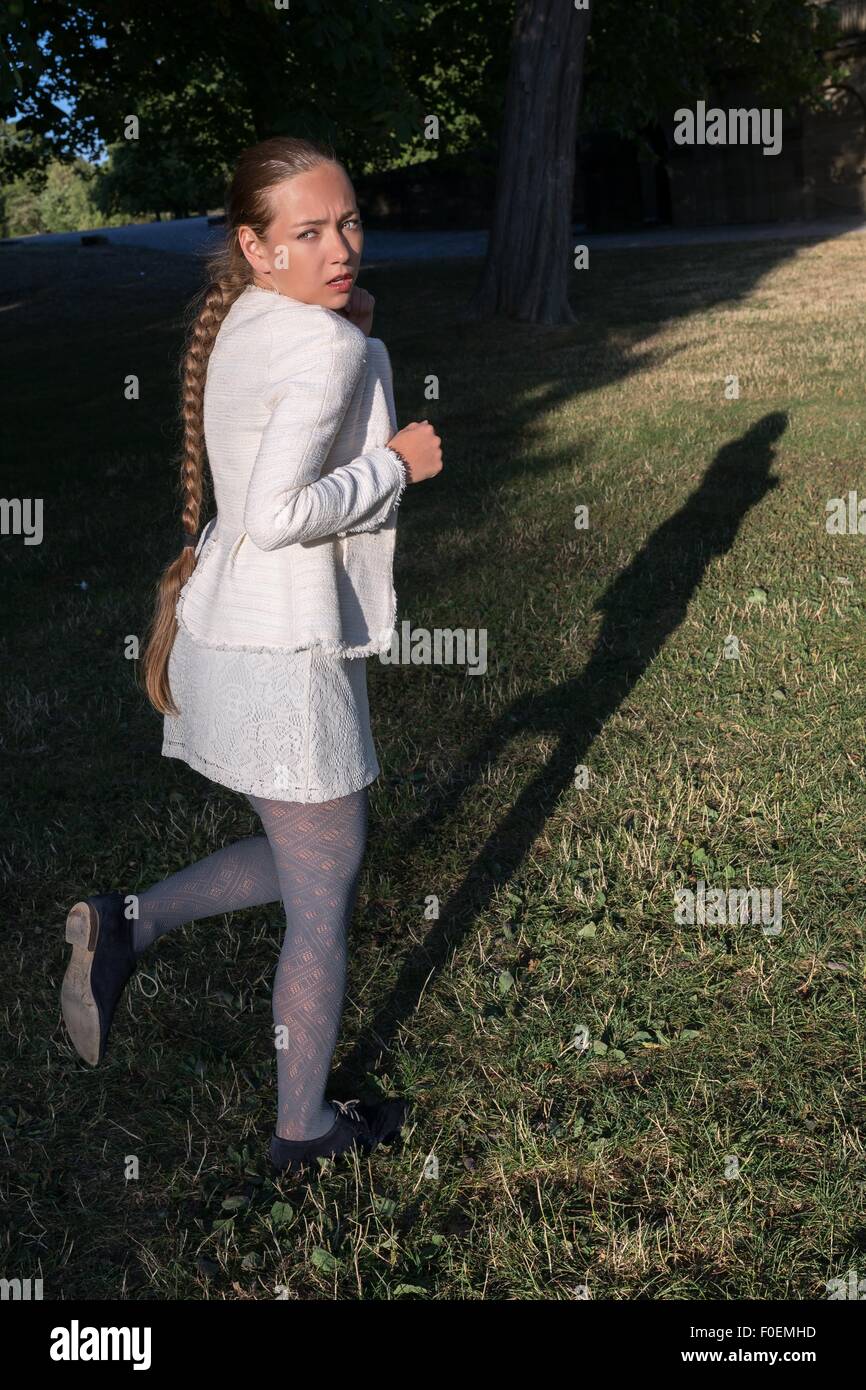 Young woman trying to escape with a running motion in a dark forest ...