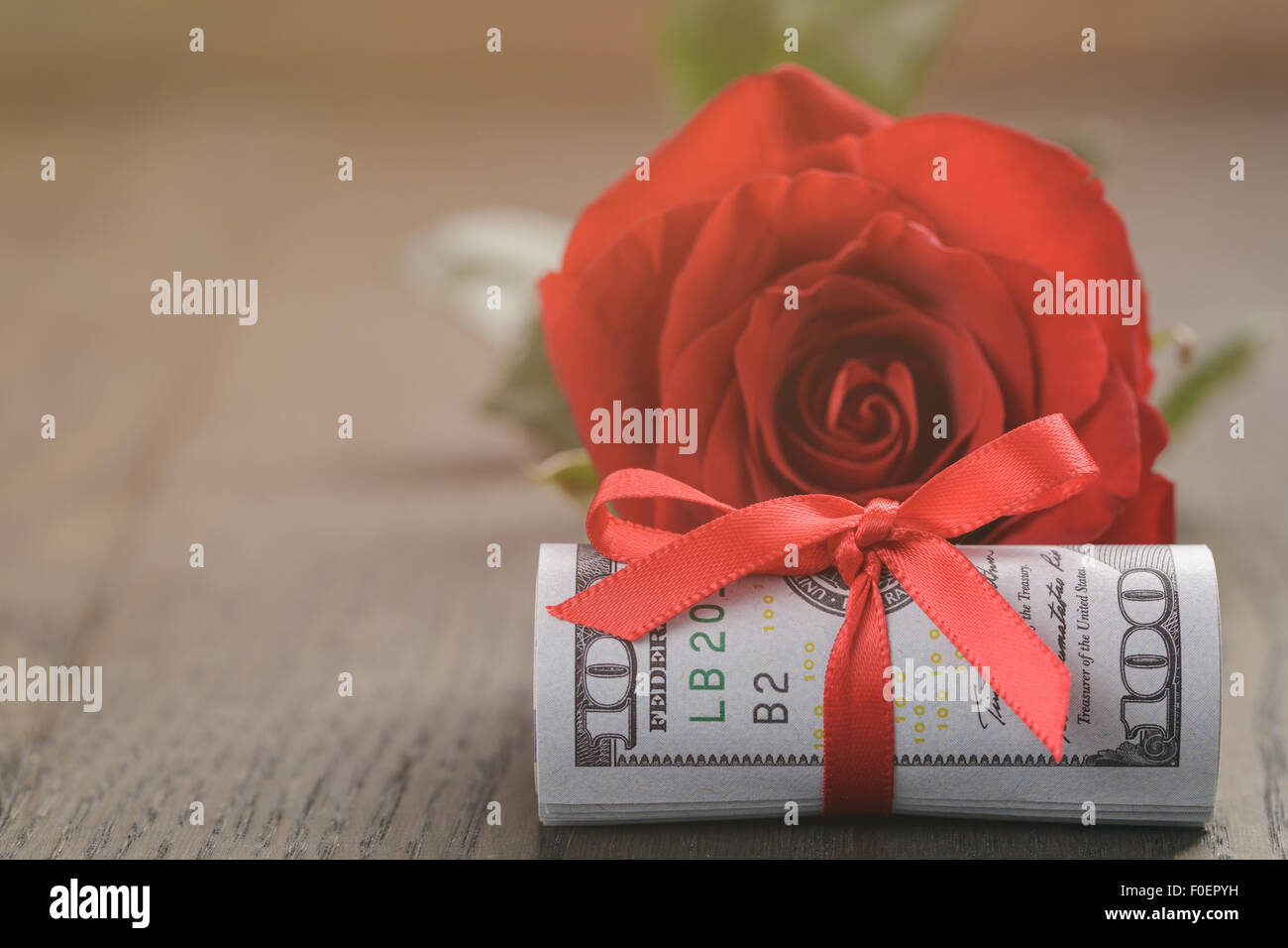 Single red rose money hi-res stock photography and images - Alamy