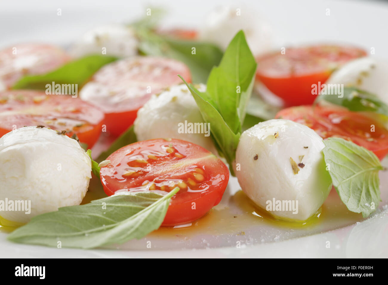 caprese salad with mini mozzarella balls and tomatoes Stock Photo - Alamy