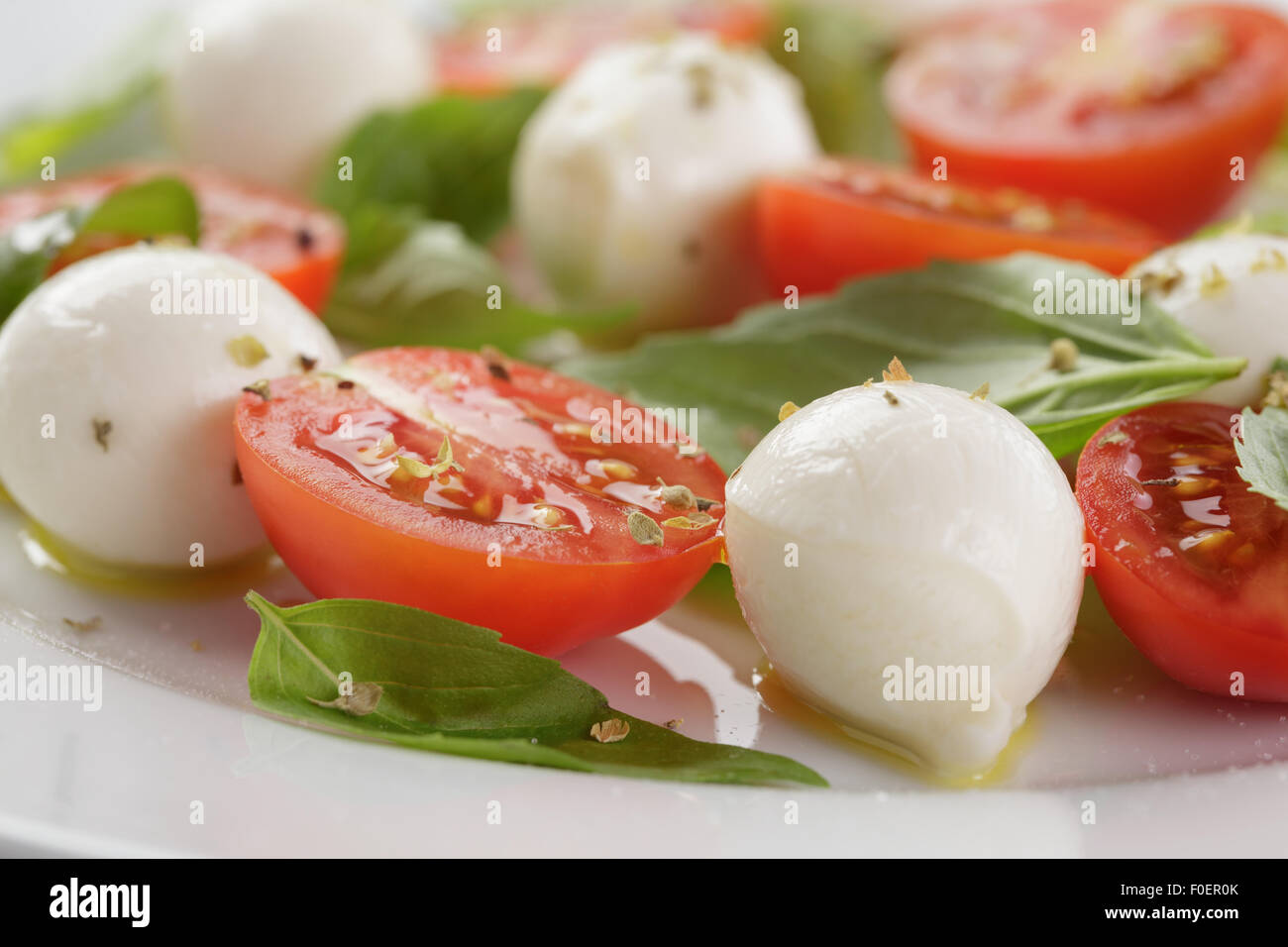 caprese salad with mini mozzarella balls and tomatoes Stock Photo - Alamy