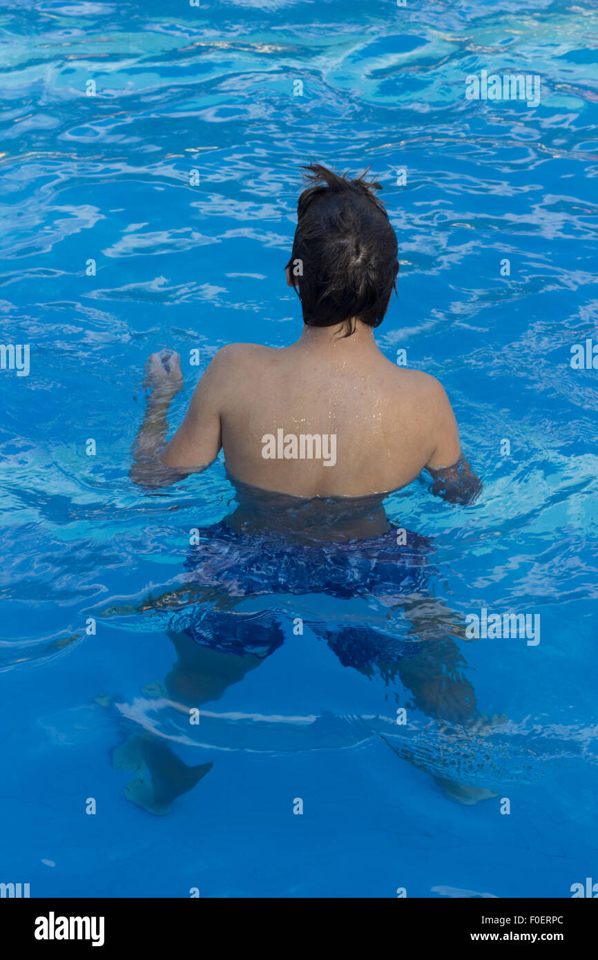 Young man stand up in a swimming pool Stock Photo - Alamy