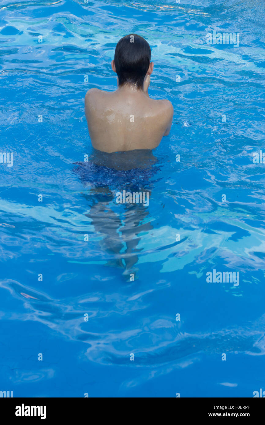 Young man stand up in a swimming pool Stock Photo - Alamy