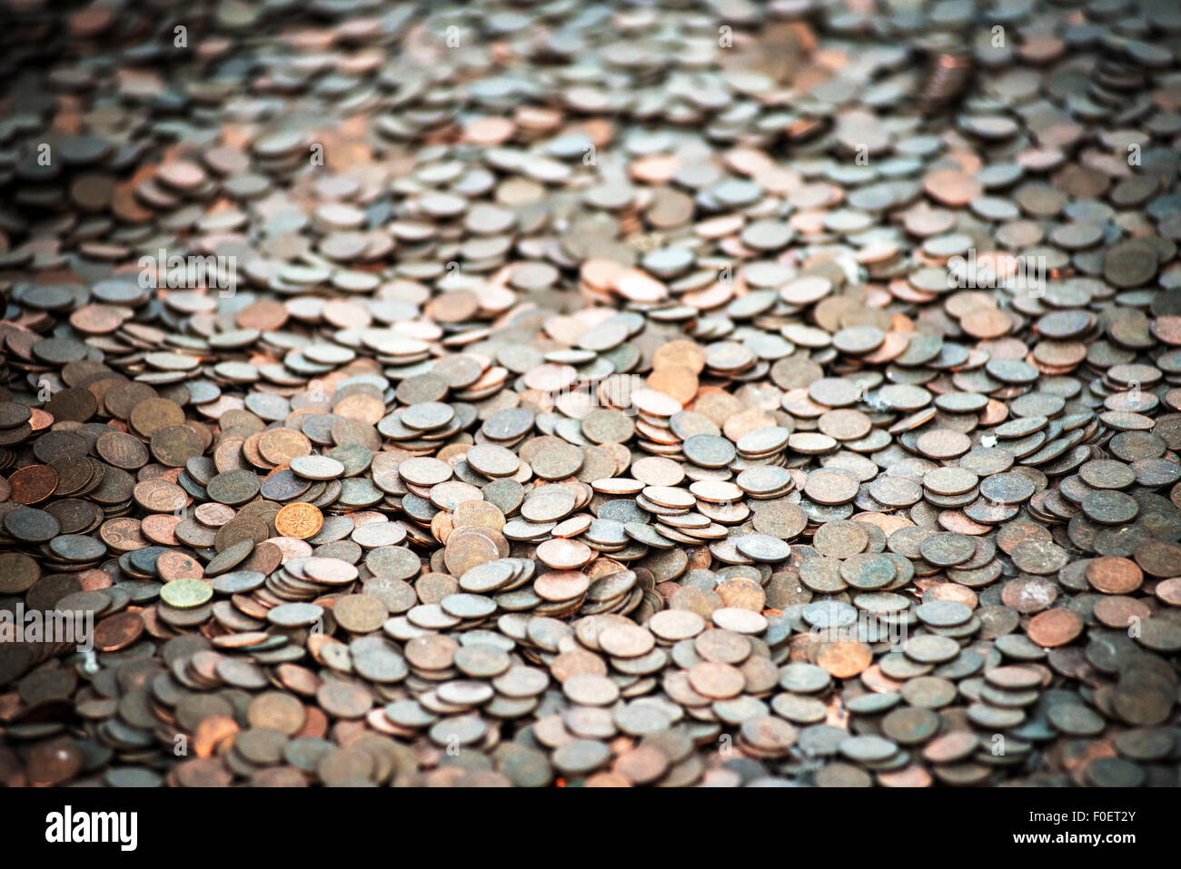Thousands of coins on the floor, spot light Stock Photo - Alamy