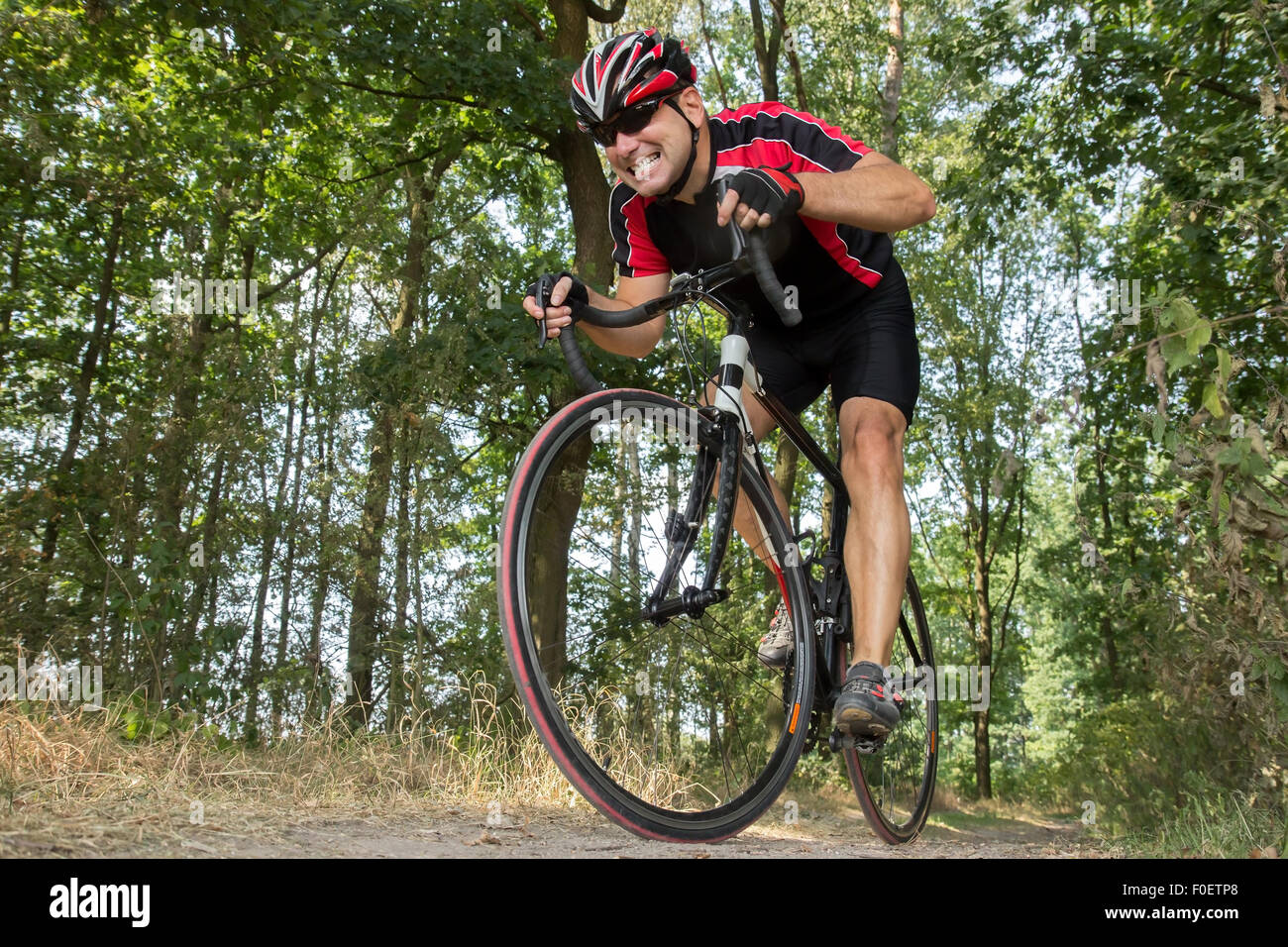 Rides bicycle on country road hi-res stock photography and images - Alamy