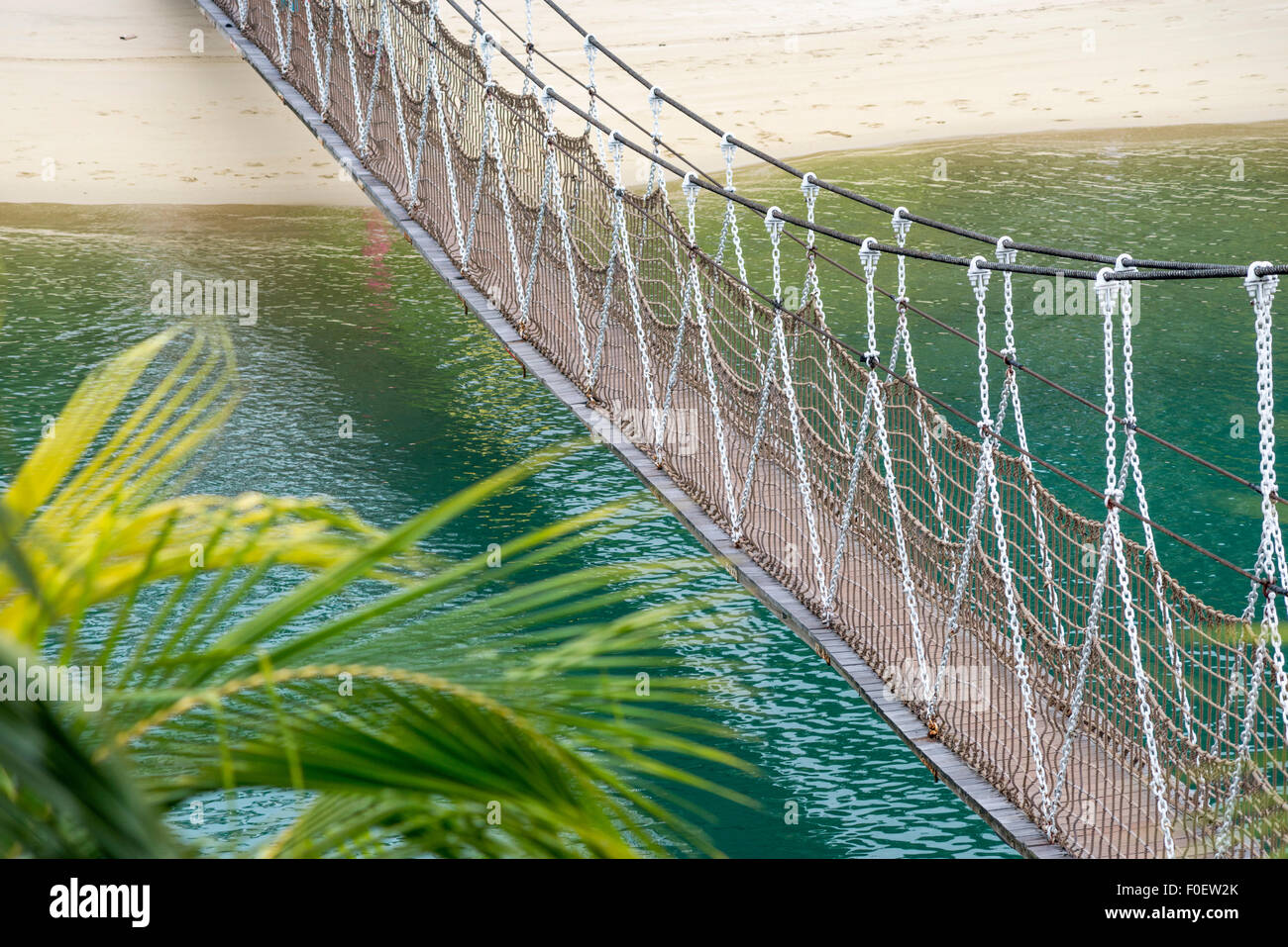 scenic hanged pedestrian rope bridge over blue sea water Stock Photo ...