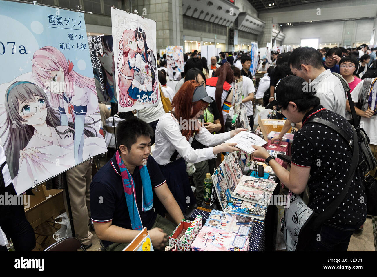 Tokyo, Japan. 14th August, 2015. Visitors look at manga books during ...