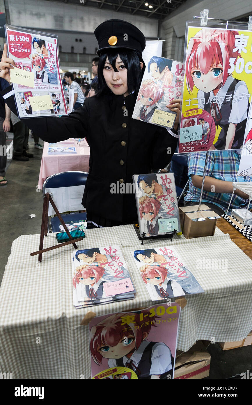 Tokyo, Japan. 14th August, 2015. An exhibitor poses for a picture ...