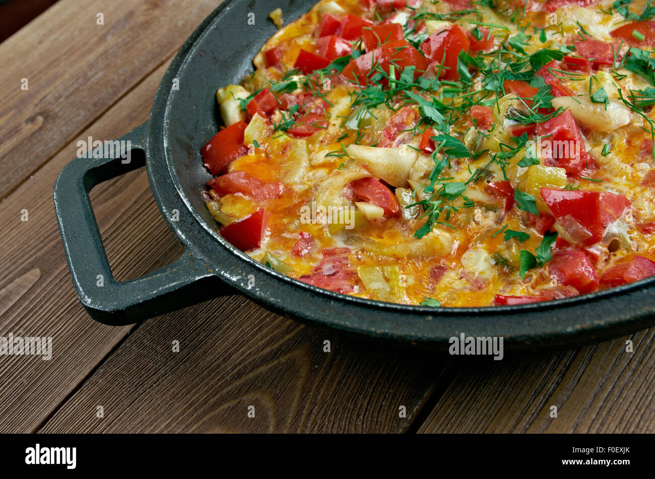 Menemen - traditional Turkish dish.includes eggs, onion, tomato, green ...