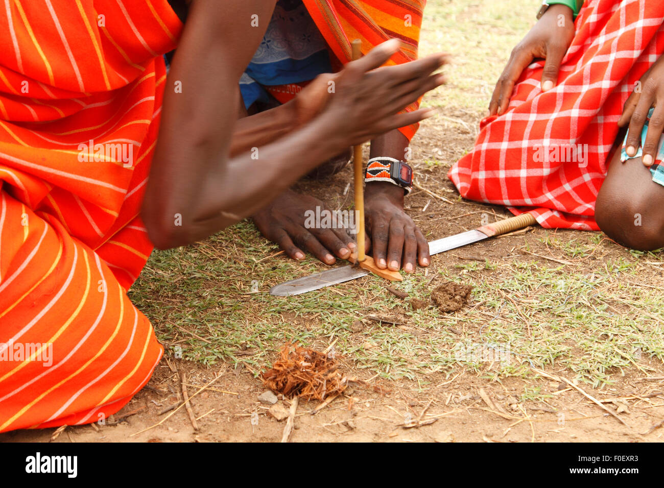 Masai men making fire using hand drill in a Masai village, Masai Mara ...