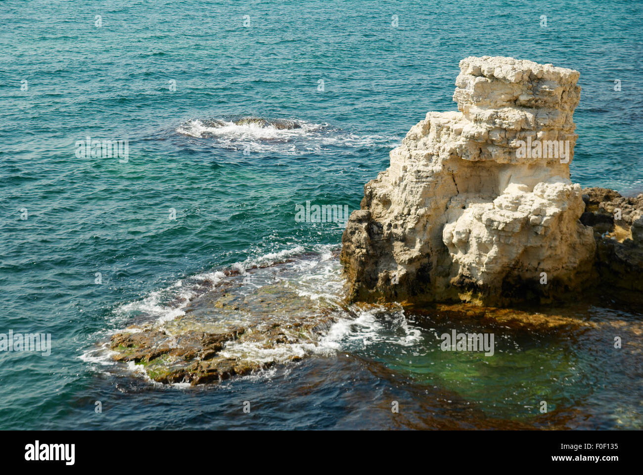 A big white rock and the ocean Stock Photo - Alamy