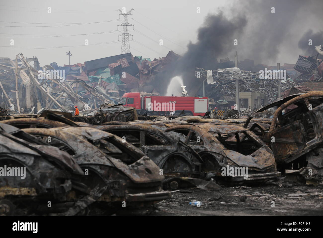 Tianjin, China. 14th Aug, 2015. Firefighters work at the warehouse ...