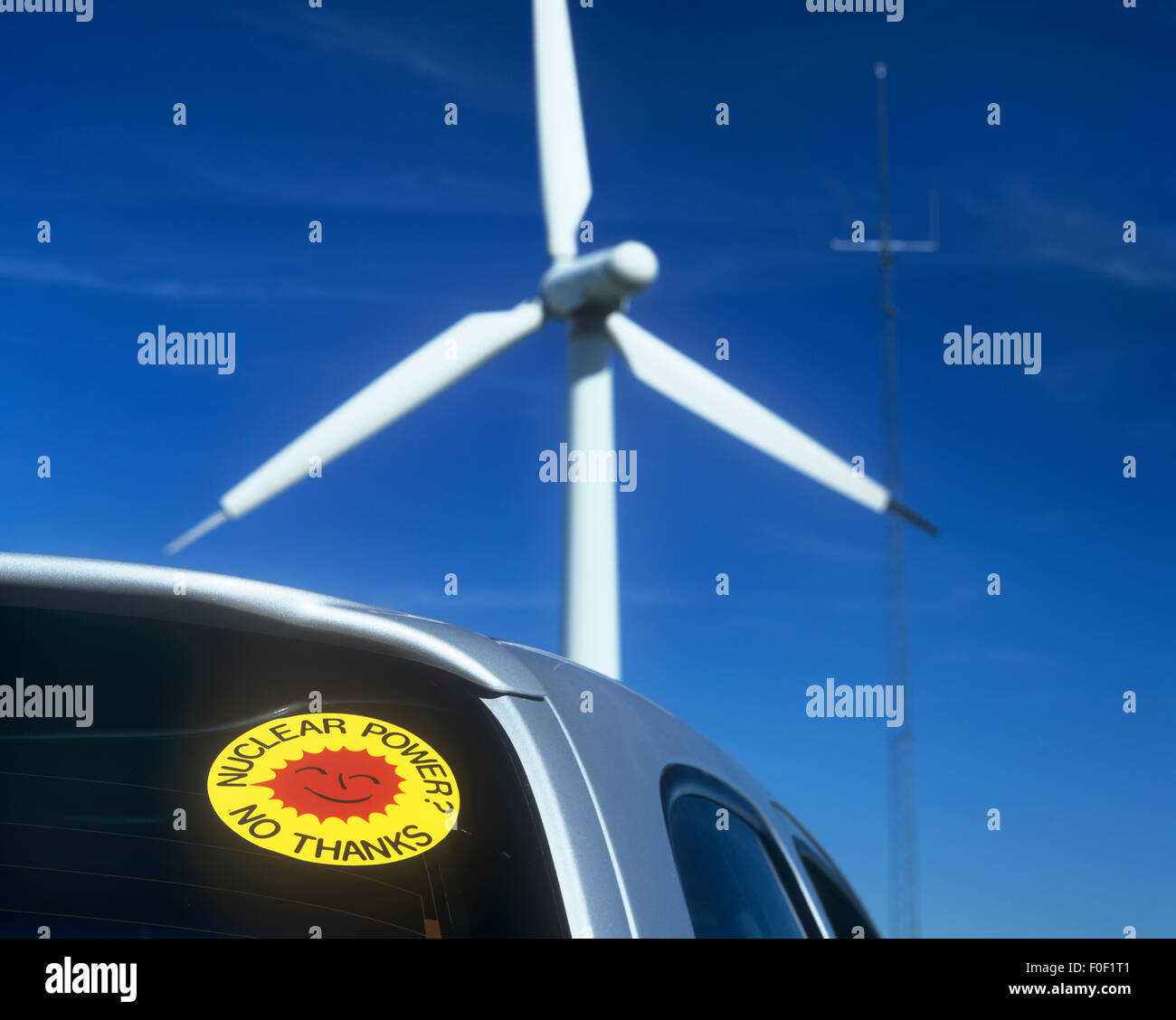 A "Nuclear Power No Thanks" smiling sun sticker on a car next to the ...