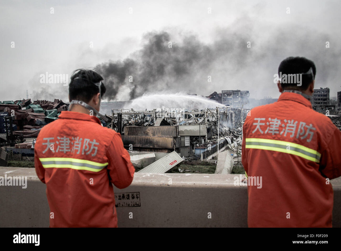 Tianjin, China. 14th Aug, 2015. Firefighters work at the warehouse ...