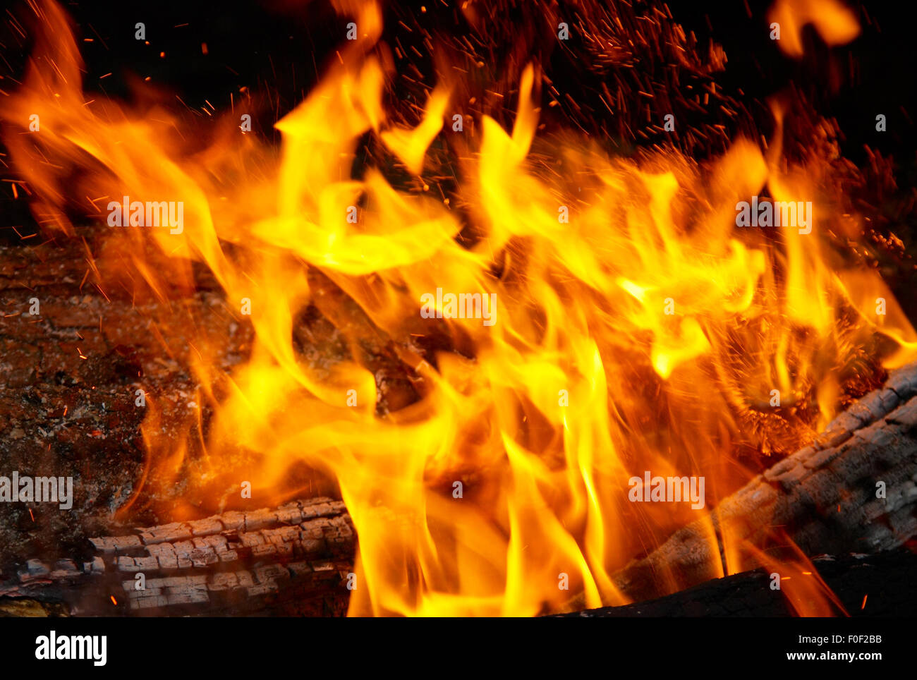 Flame tips on the firewood Stock Photo - Alamy