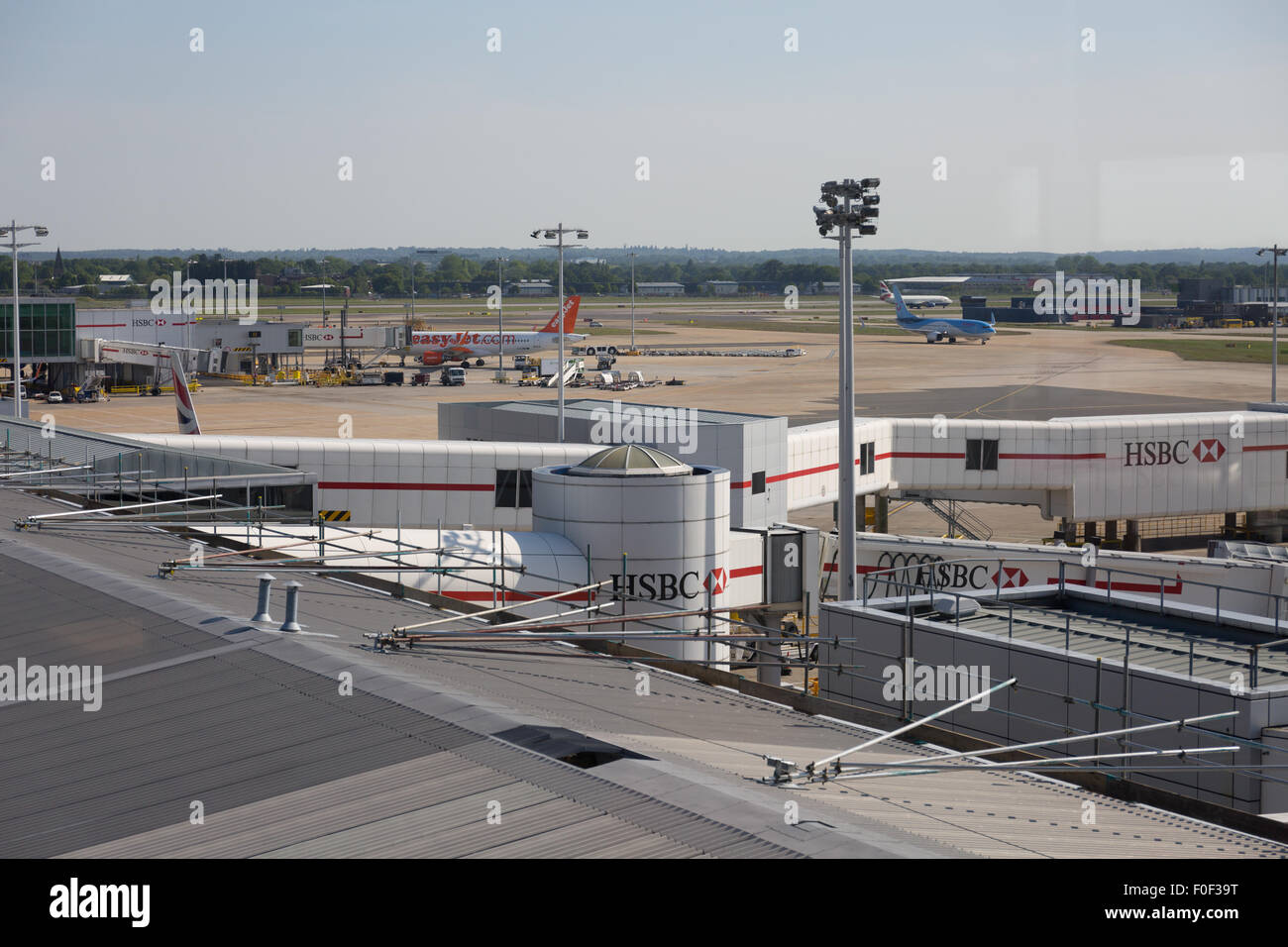 Gatwick airport apron with Easyjet plane and HSBC jet bridge Stock ...