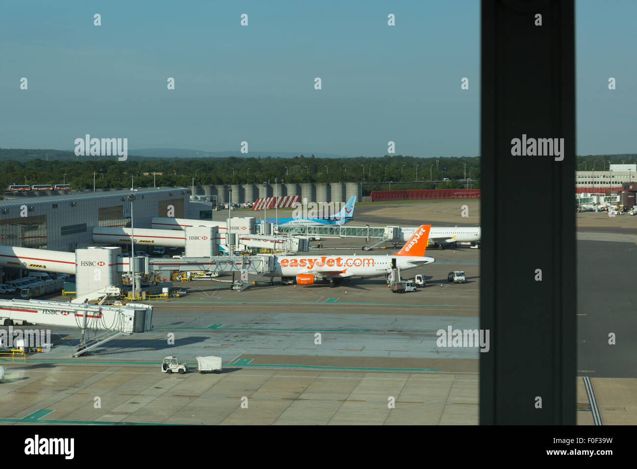 Gatwick airport apron with Easyjet plane and HSBC jet bridge Stock ...