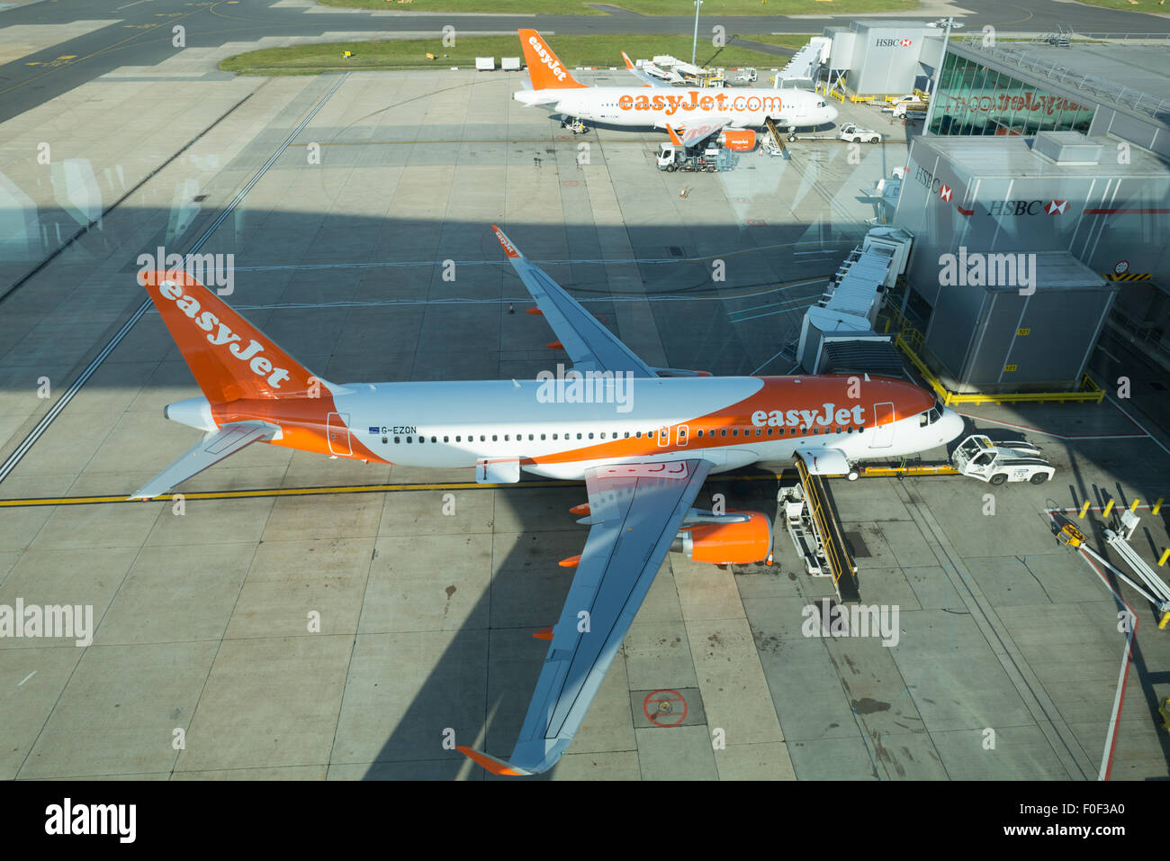 Gatwick airport apron with Easyjet plane and HSBC jet bridge Stock ...