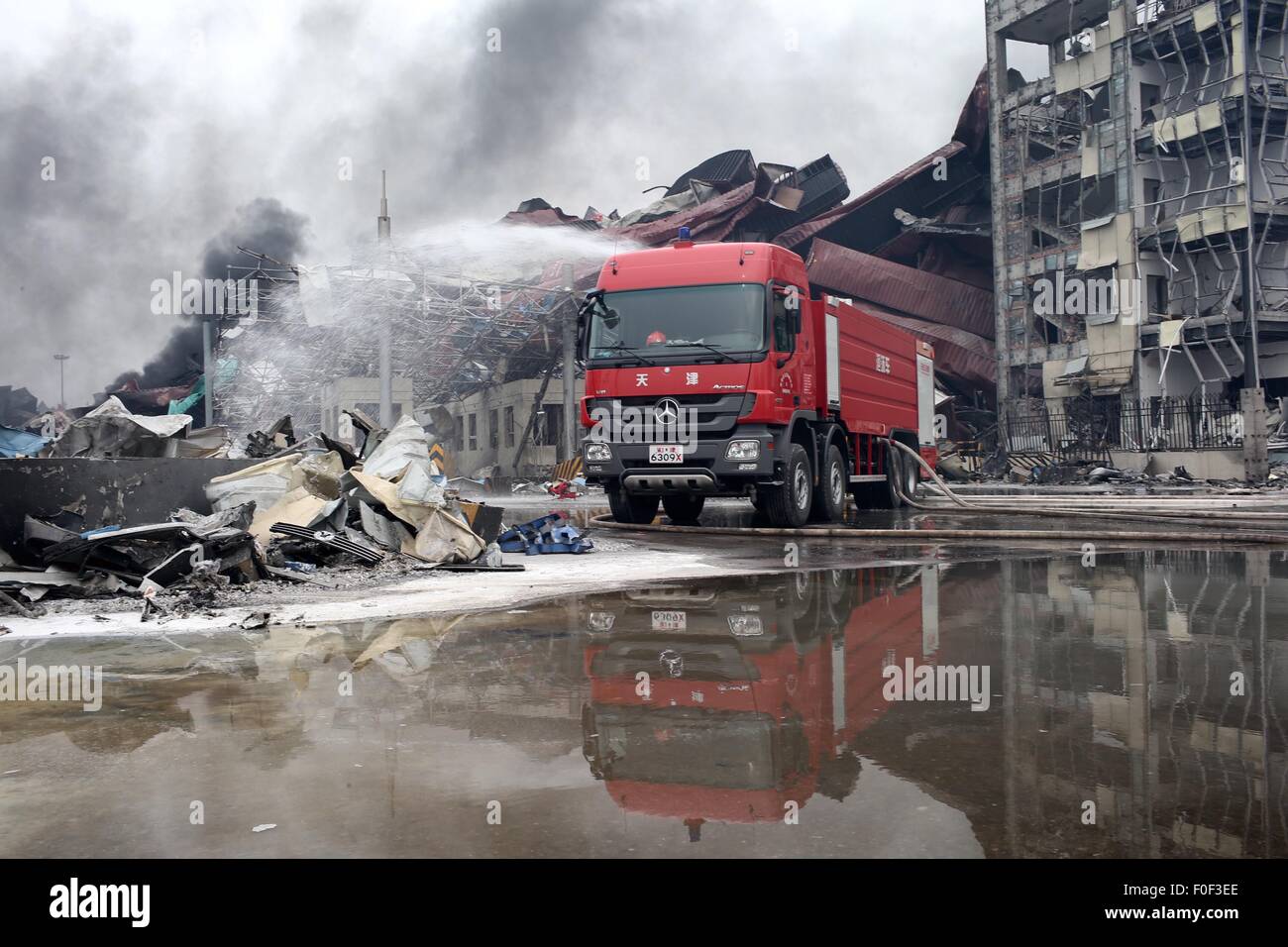 Tianjin, China. 14th Aug, 2015. Firefighters work at the warehouse ...