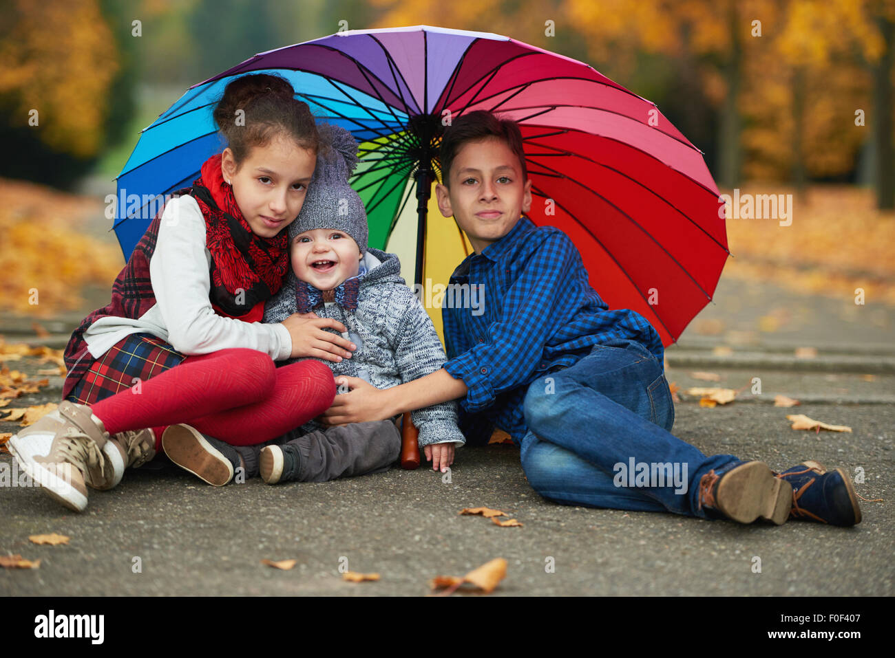 happy children under rainbow umbrella Stock Photo - Alamy