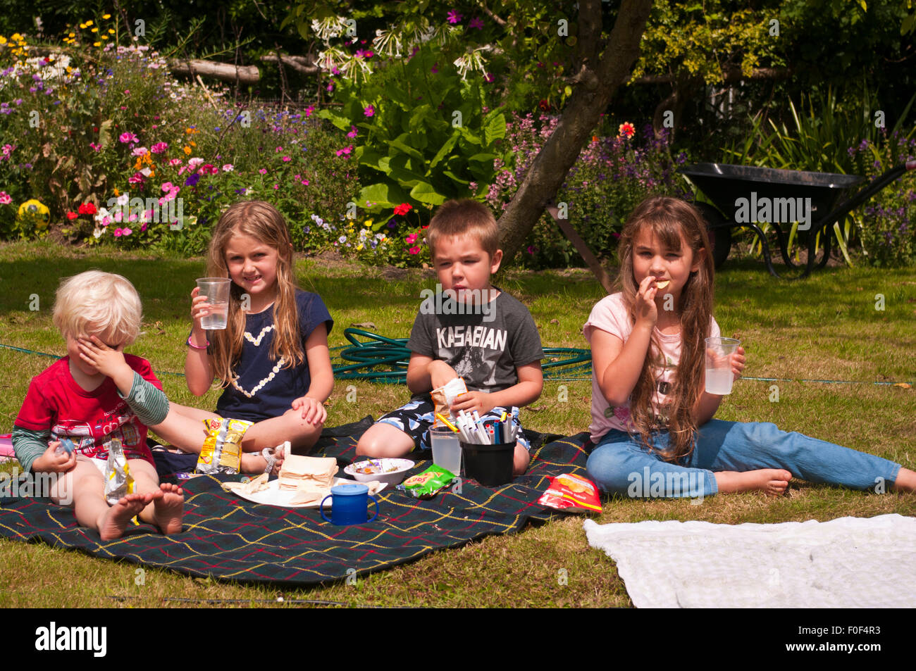 Children having a Picnic In The Garden On a summers day Stock Photo - Alamy