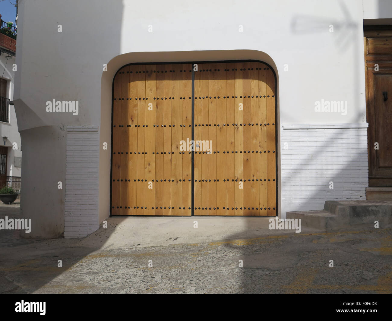 Traditional Andalusian wooden doors with big iron studs Stock Photo - Alamy