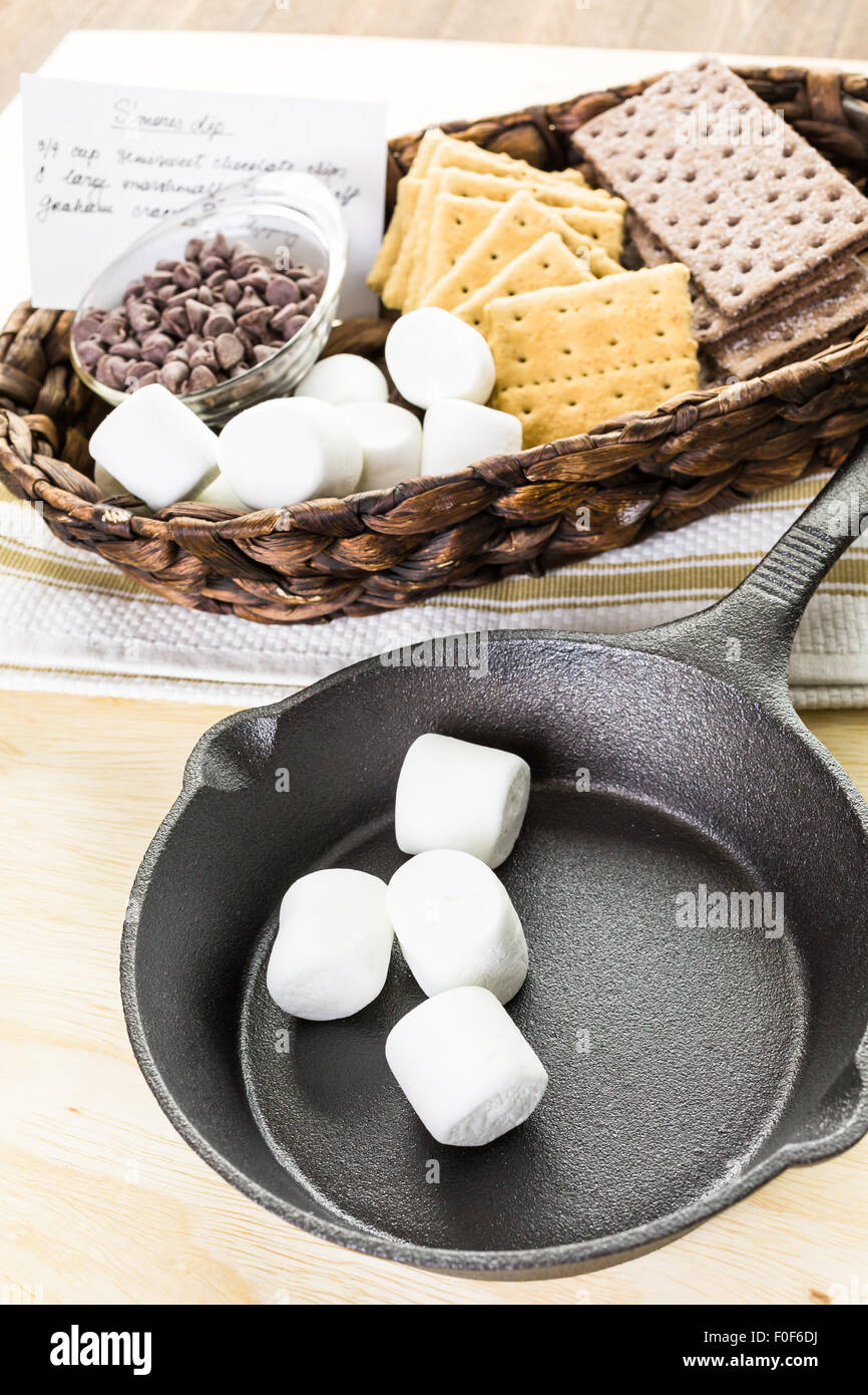 Ingredients smores dip prepared with large marshmallows in cast iron ...