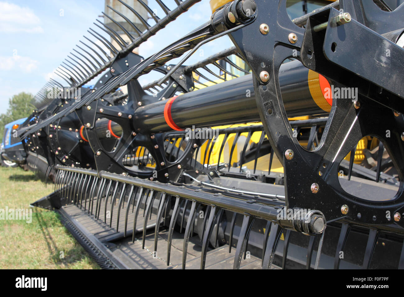 Closeup of harvesting machinery while working the field Stock Photo - Alamy
