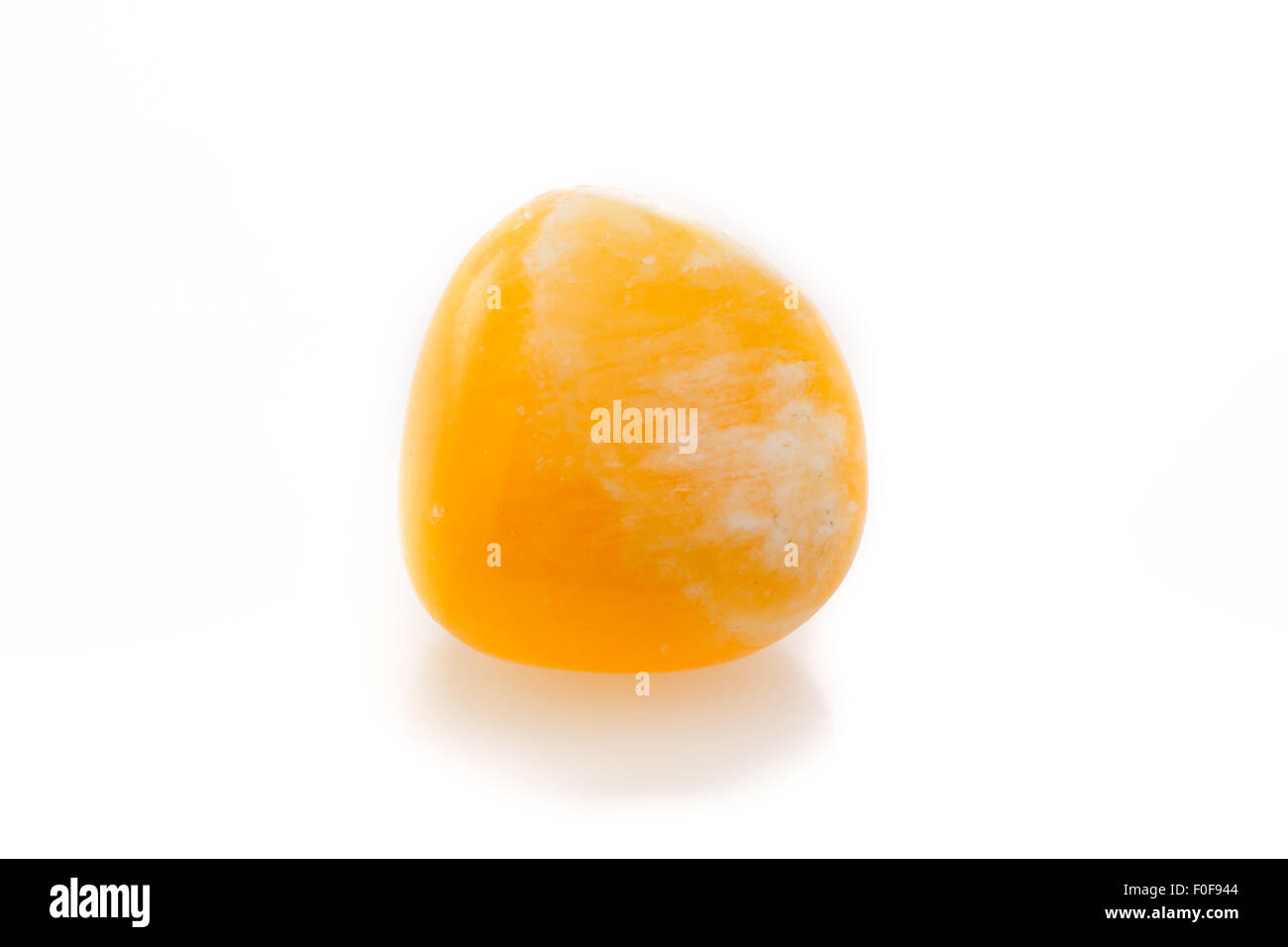 Bright orange calcite on a white background Stock Photo - Alamy