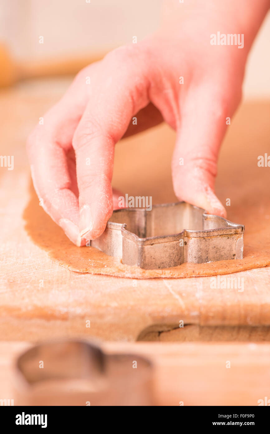 Hand of woman baking ginger bread cookies as christmas preparation ...