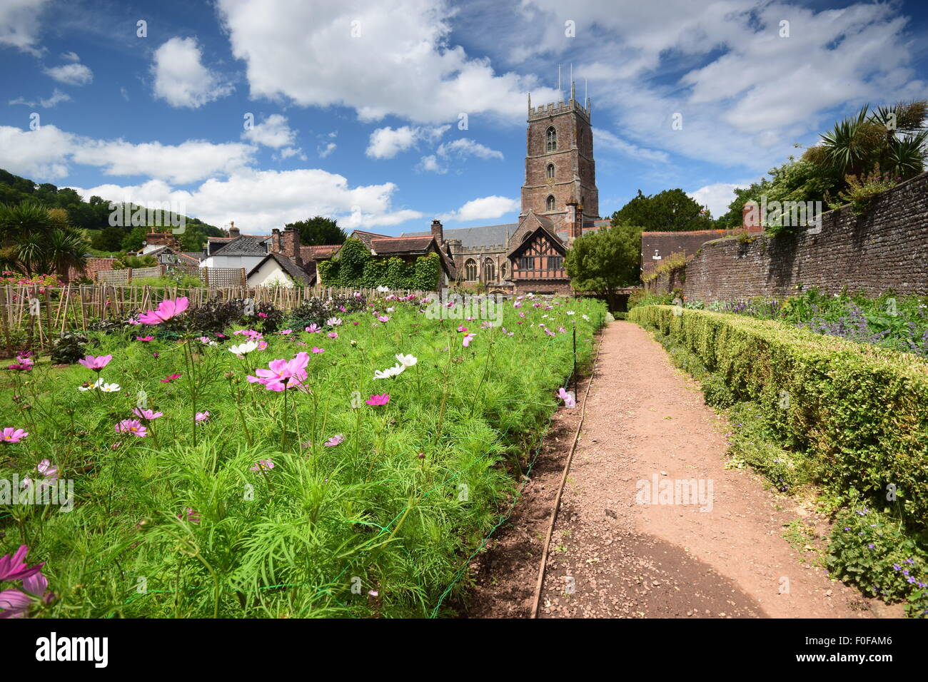 The idyllic English village of Dunster in Somerset, the flowers ...