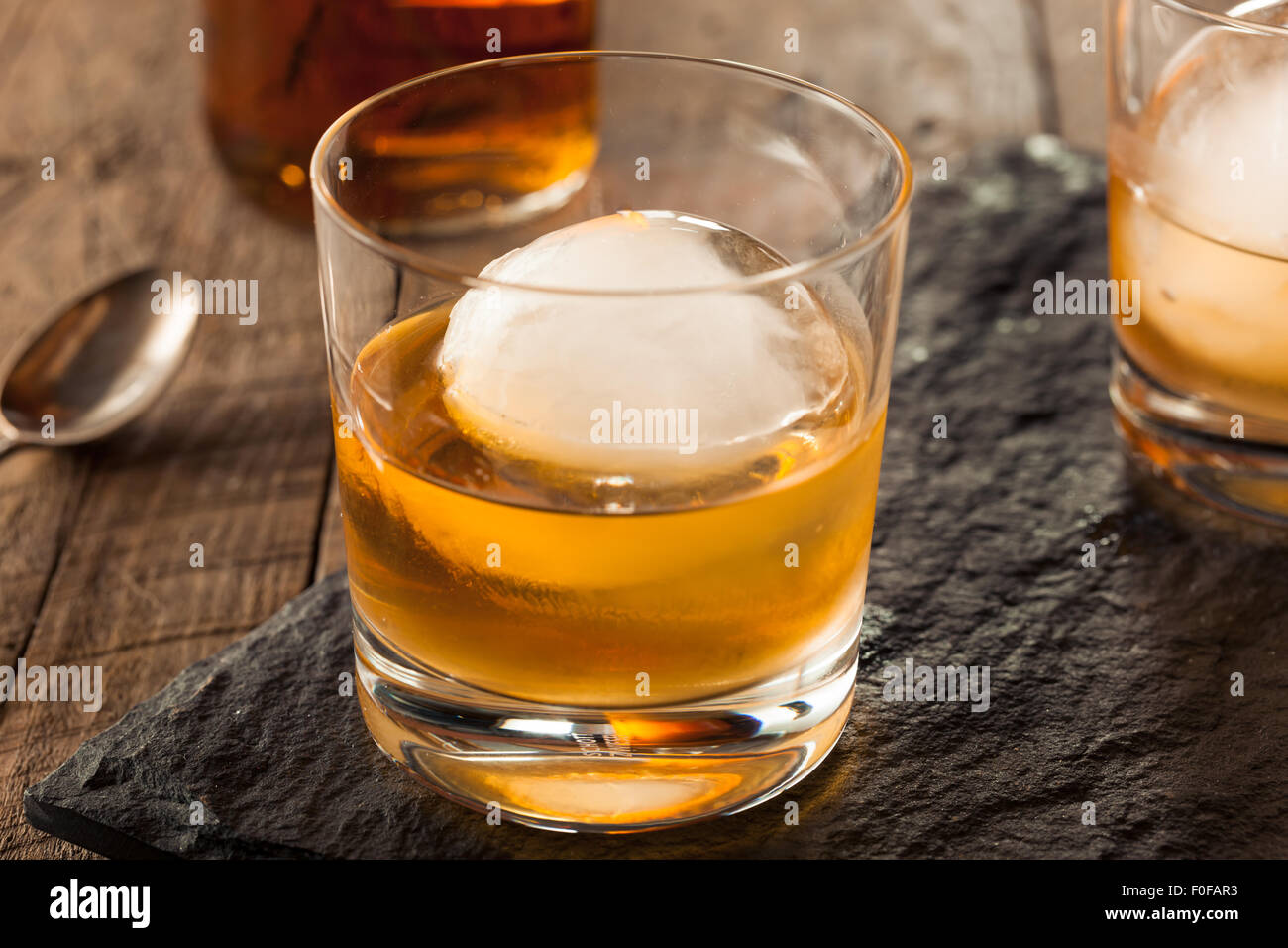 Bourbon Whiskey with a Sphere Ice Cube Ready to Drink Stock Photo - Alamy