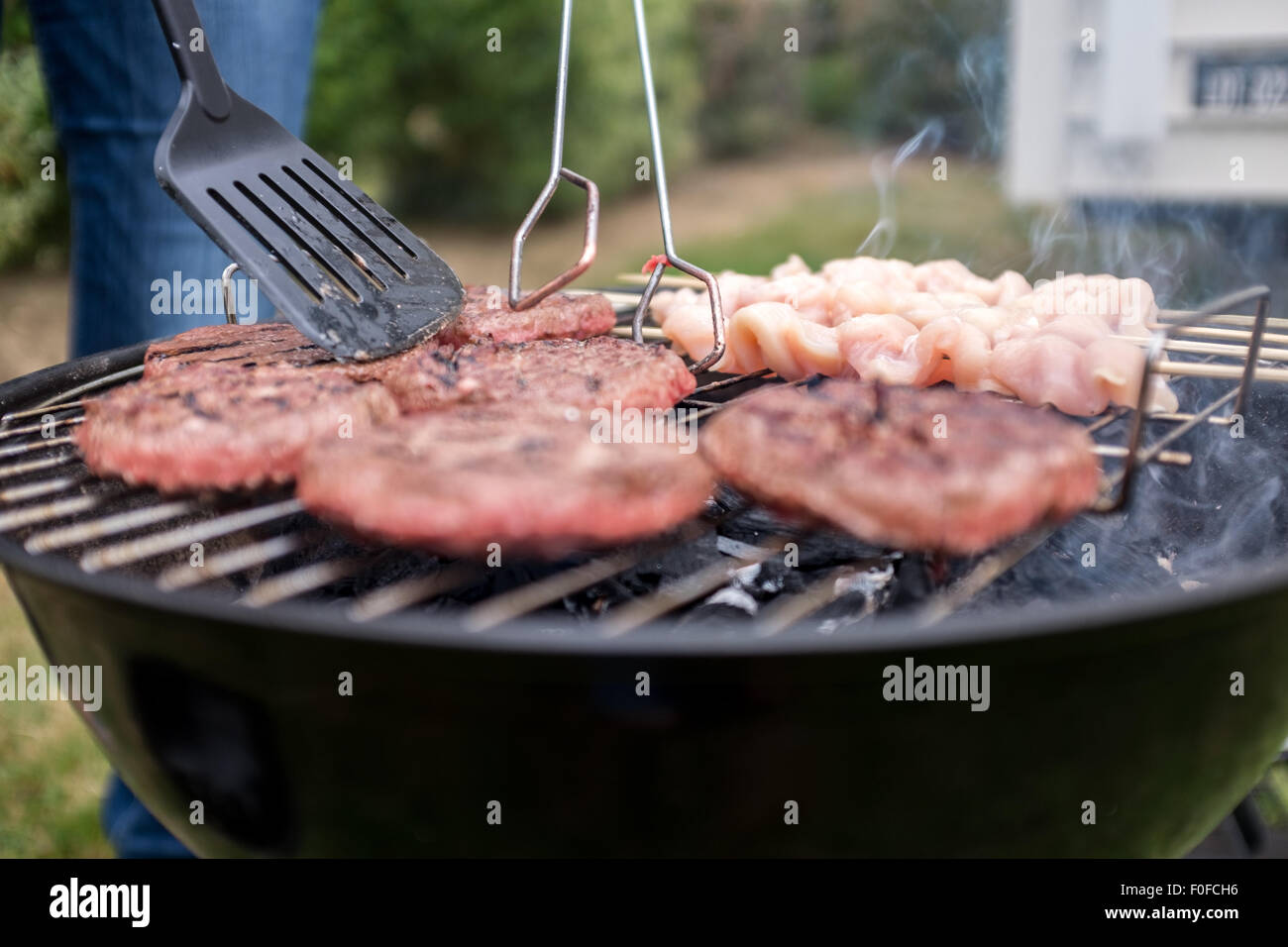 Meat cooking on an outdoor barbeque Stock Photo - Alamy