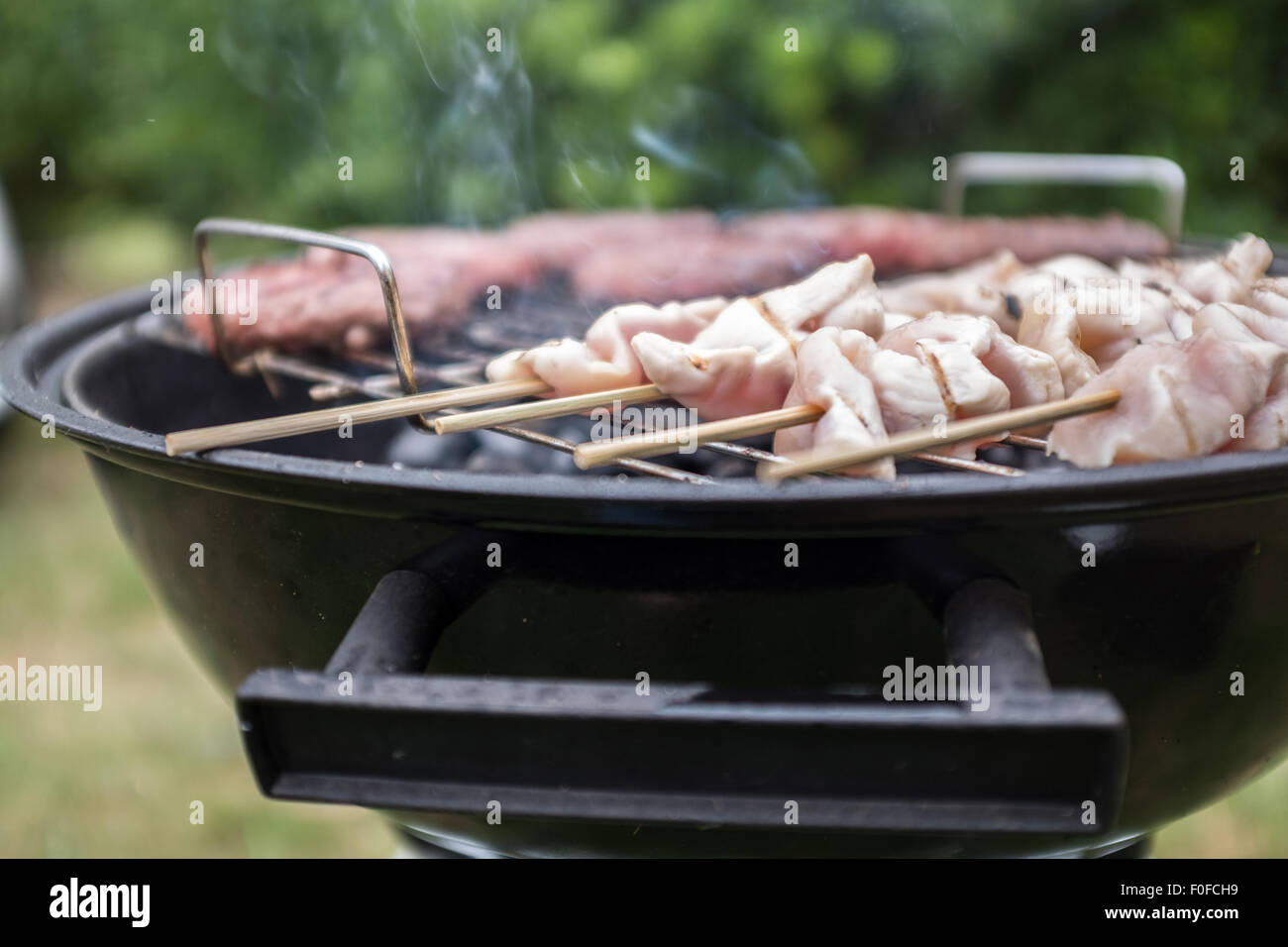 Meat cooking on an outdoor barbeque Stock Photo - Alamy