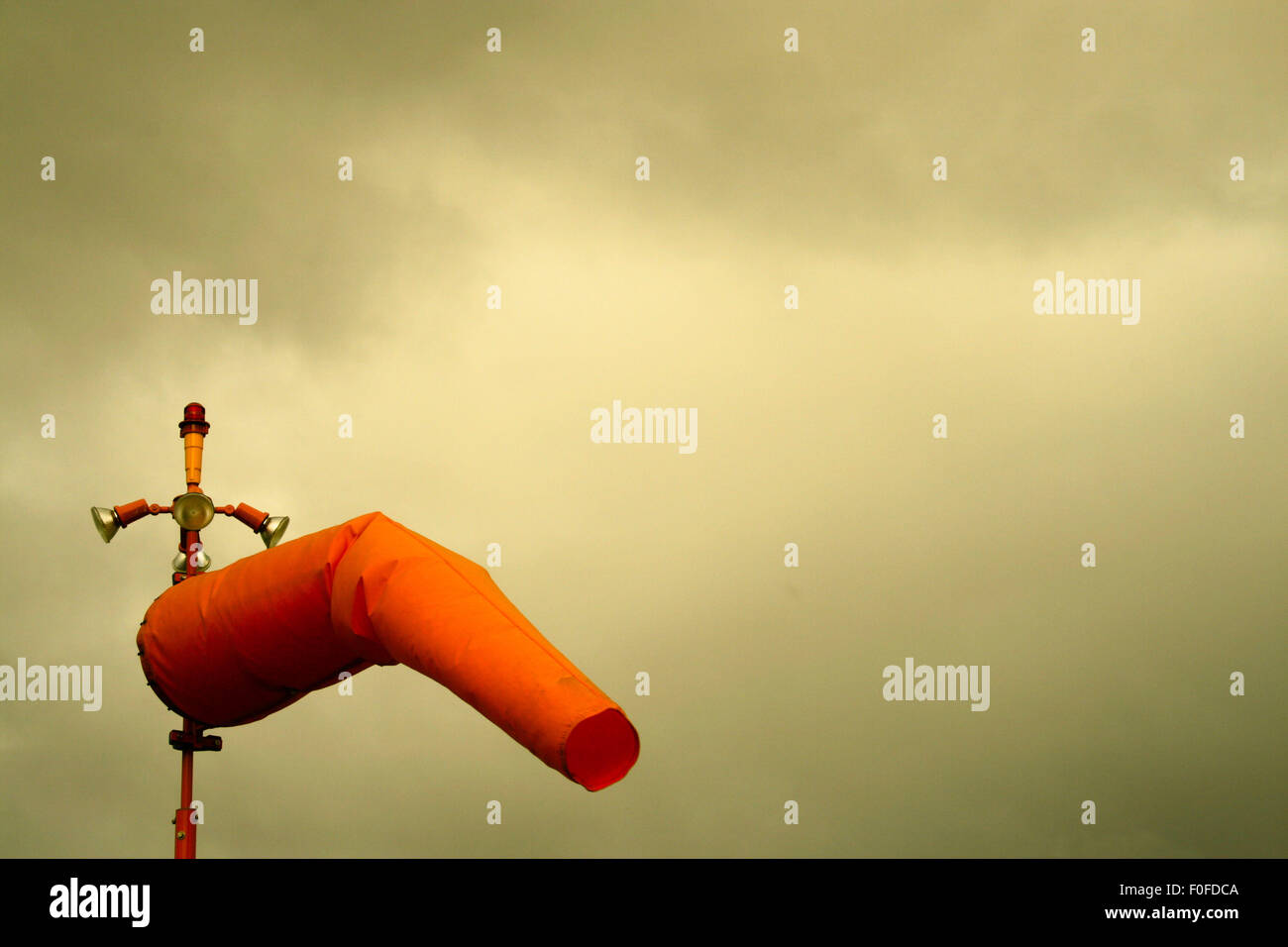 An orange windsock in the stormy weather Stock Photo - Alamy