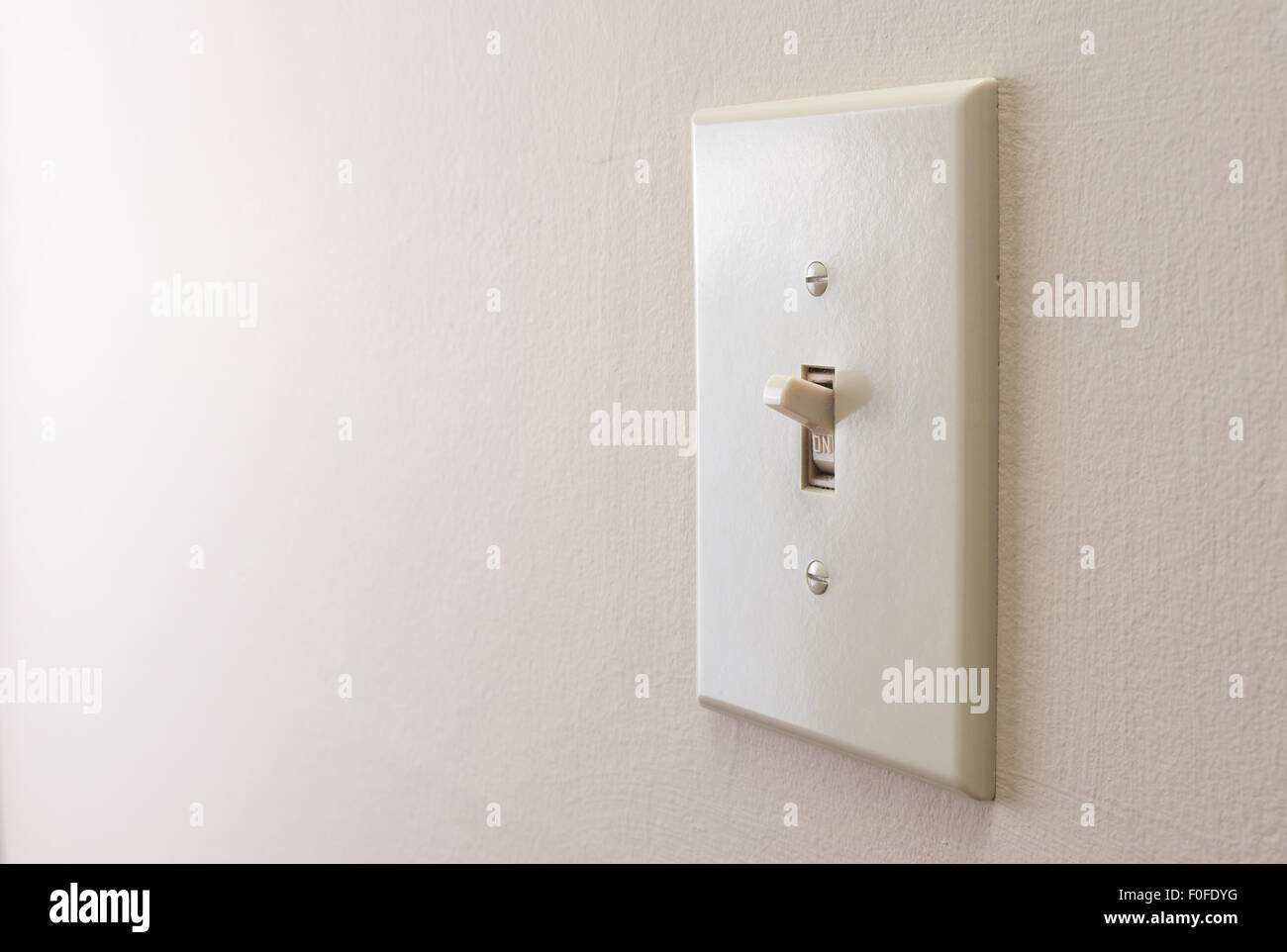 Classic light switch hanging on the wall Stock Photo - Alamy