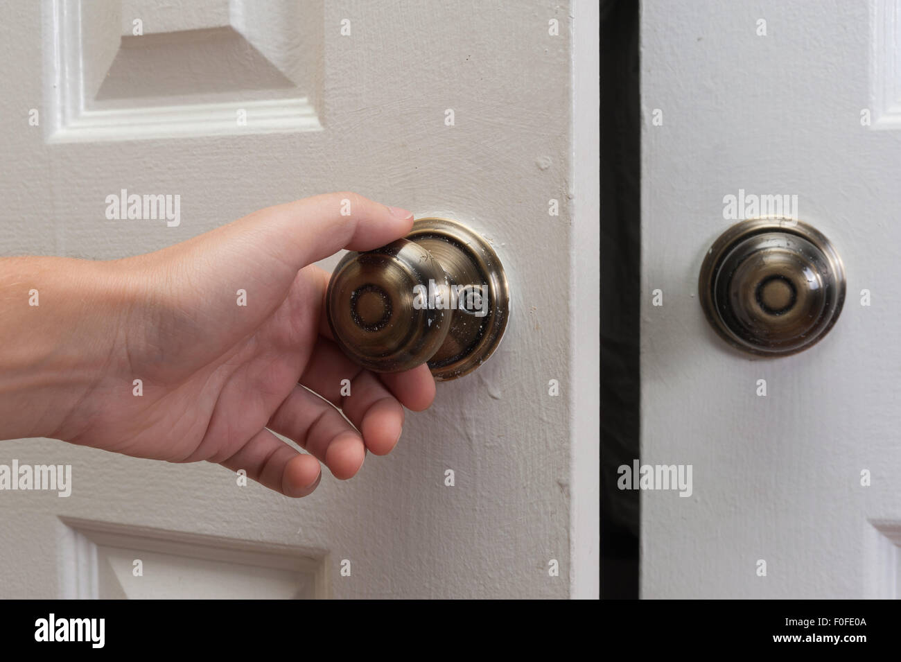 Hand opening the door close up Stock Photo - Alamy