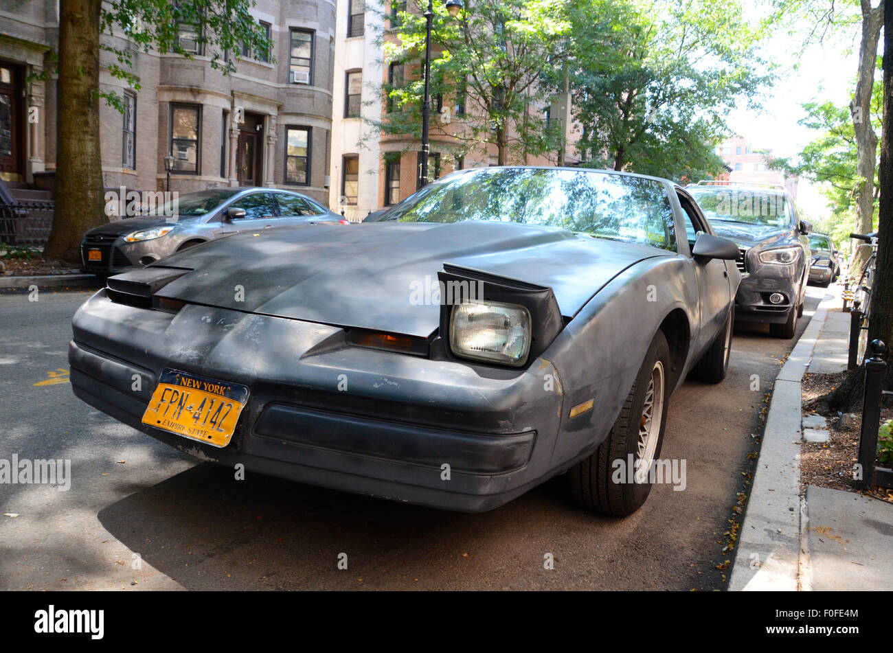 pontiac matt black car one head light battered new york plates Stock ...