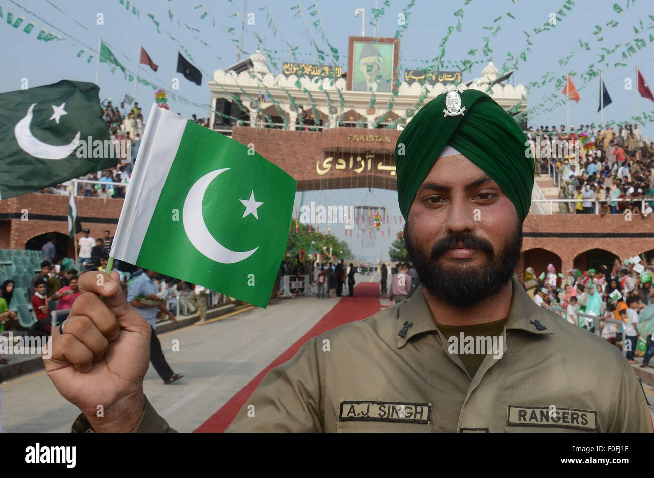 Lahore, Pakistan. 14th Aug, 2015. A ranger waving his national flag-let ...