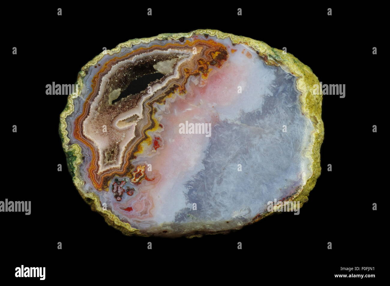 Agate, a cross section of agate stone with geode on a black background ...
