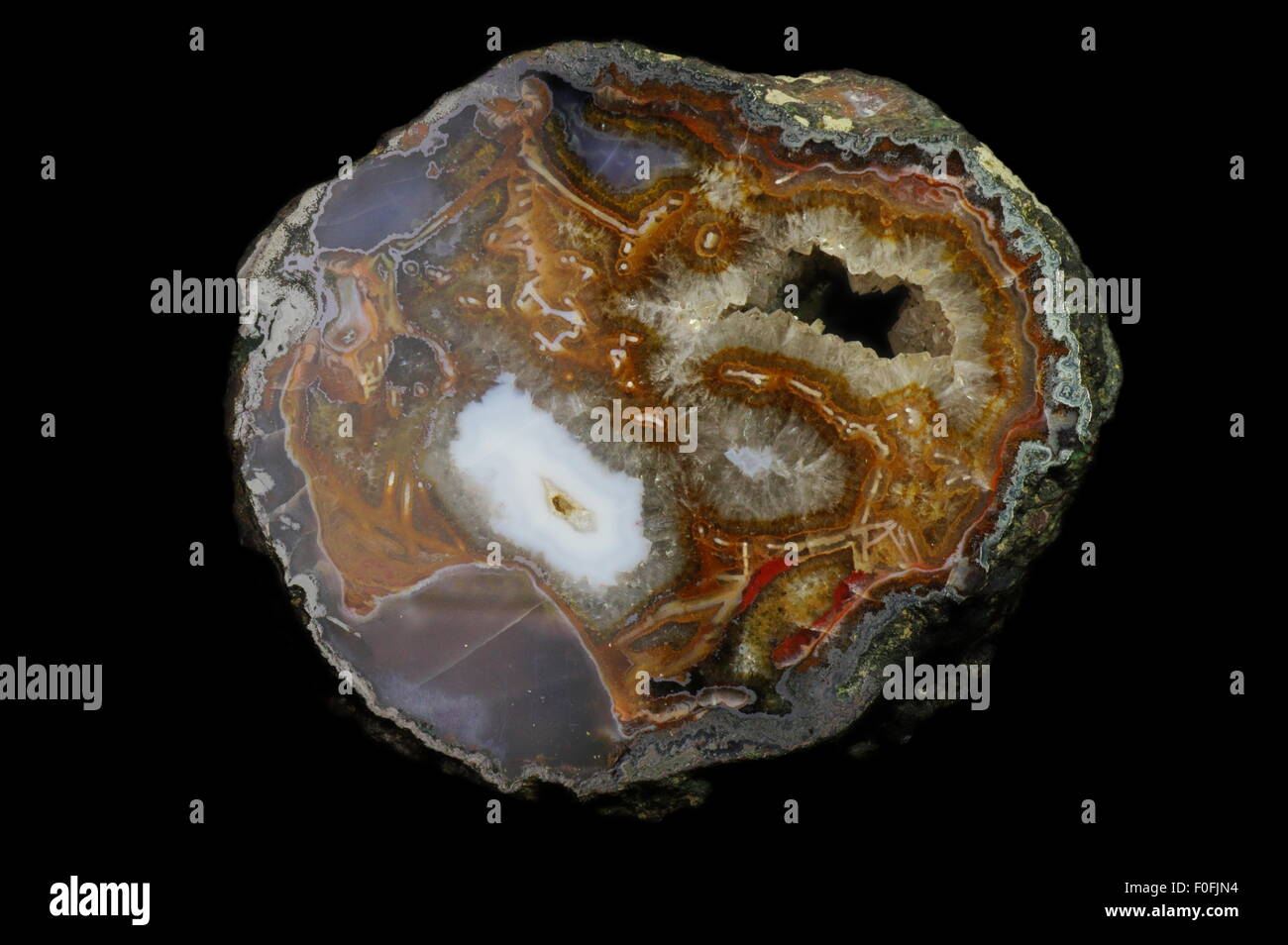 Agate, a cross section of agate stone with geode on a black background ...