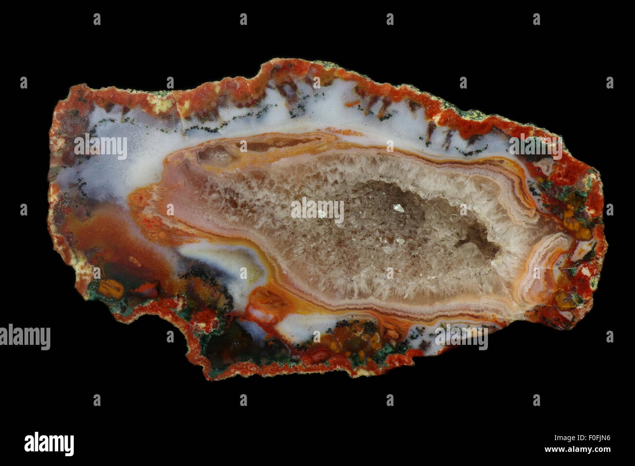 Agate, a cross section of agate stone with geode on a black background ...