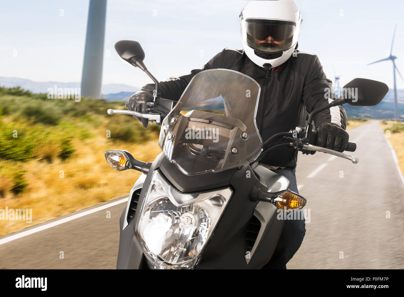Biker in helmet and leather jacket riding on the road Stock Photo - Alamy
