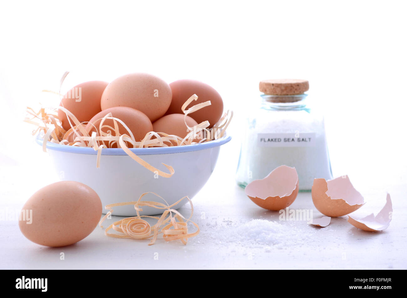 Farm fresh eggs in vintage bowl with broken egg shells and salt on ...