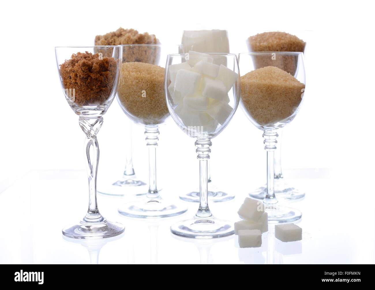 Different types of sugar including white, brown, dark brown, demerara ...