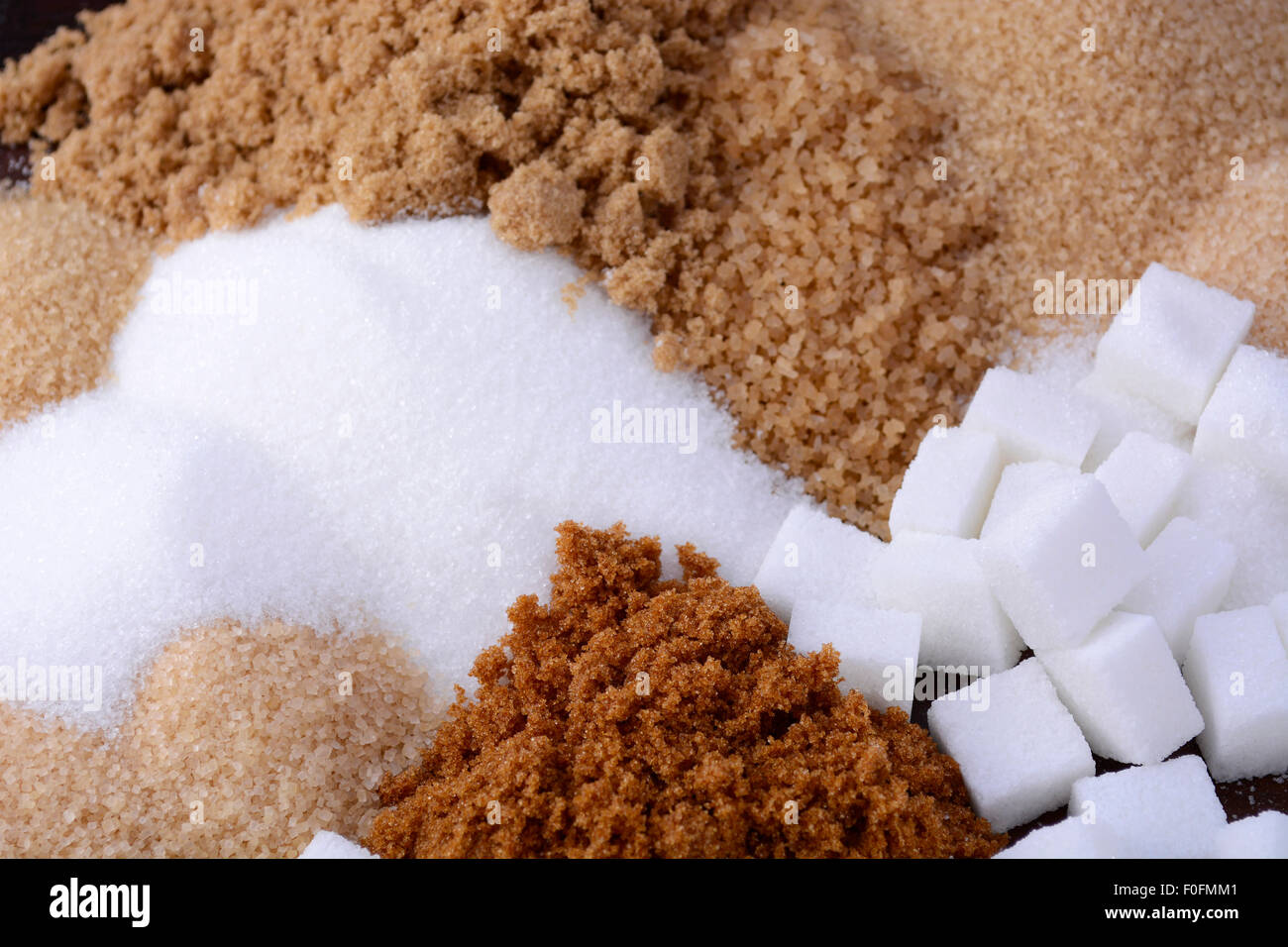 Different types of sugar including white, brown, dark brown, demerara ...