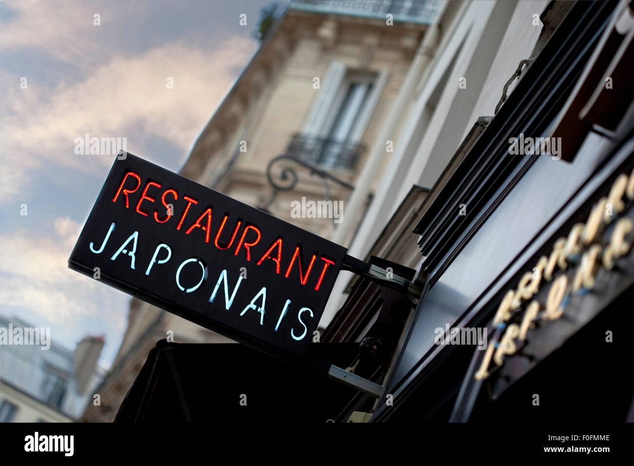 Neon sign of a Japanese restaurant in a French town Stock Photo - Alamy